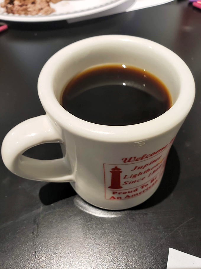 The coffee mug says it all – lighthouse pride in every sip. Strong enough to wake you up but smooth enough to keep you coming back.