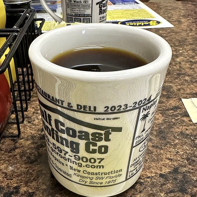 The coffee comes in mugs advertising local businesses&mdash;a charming touch that reminds you this is a place where community still matters.