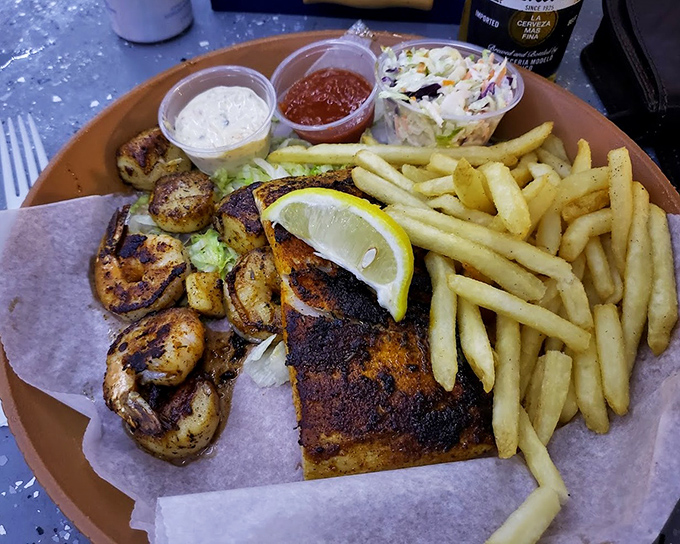 Blackened fish with a side of perfectly grilled shrimp&mdash;proof that sometimes the best things in life come on paper plates.