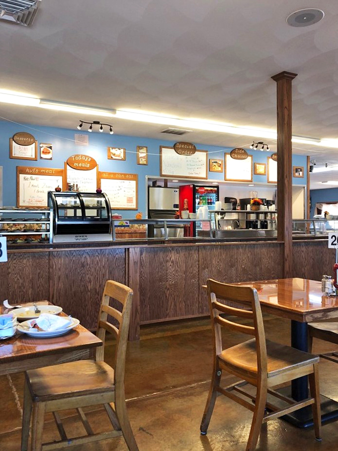 The counter area where magic happens, complete with chalkboard menus and enough homemade baked goods to derail any diet immediately.