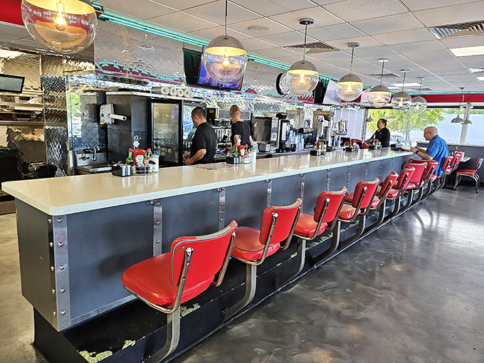 The counter seating&mdash;where solo diners become temporary family and coffee refills arrive before you realize you need one.
