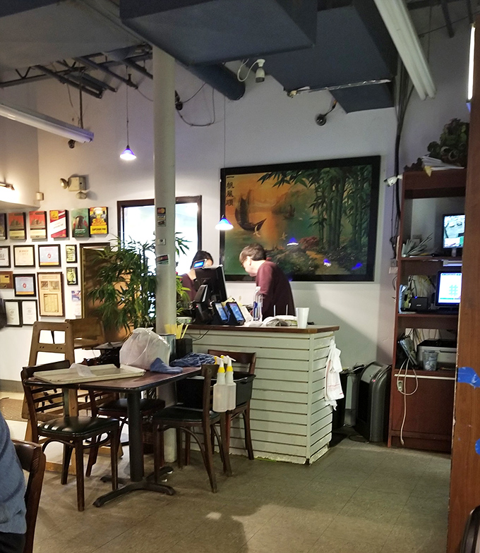 The heart of operations: where orders are taken, to-go packages are prepared, and the wall art hints at the cultural heritage behind every dish.