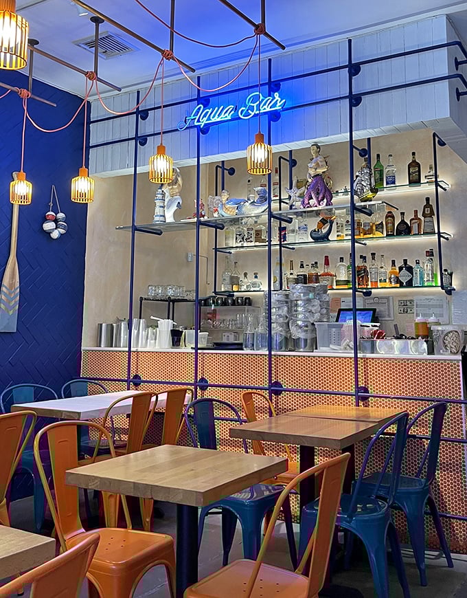 The bar area doubles as seafood theater, where bottles gleam like jewels and the promise of perfectly paired drinks awaits.