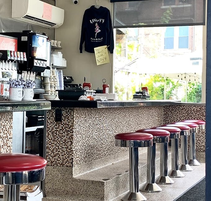 Red vinyl stools lined up like patient soldiers, waiting for the next shift of hungry patrons to claim their territory.