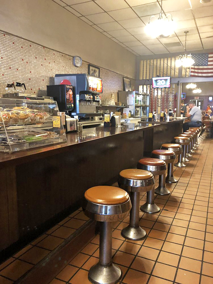 Classic diner stools lined up like soldiers, ready for the next shift of hungry patrons seeking comfort in familiar flavors.