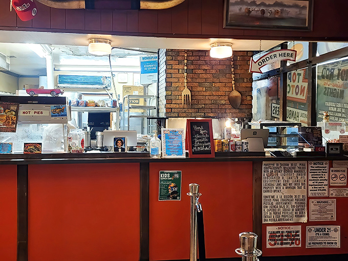 The ordering counter with its brick backdrop and nostalgic signage feels like stepping into a time machine that serves burgers.