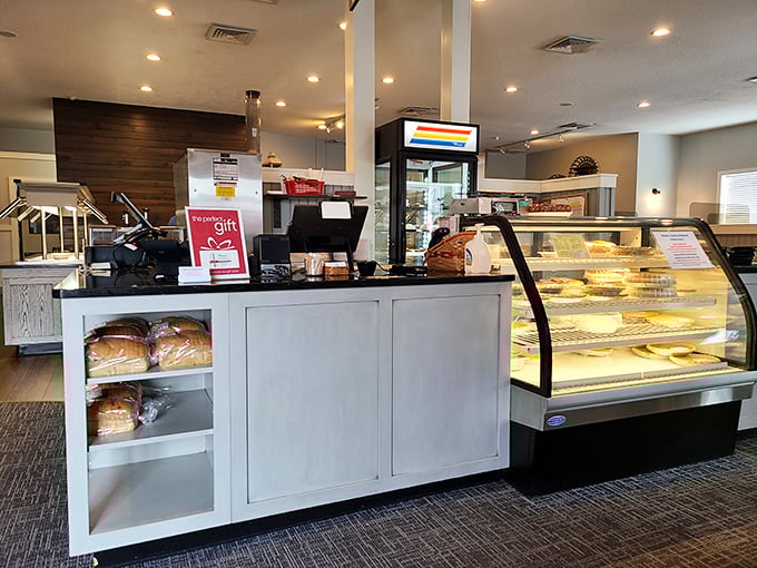 The bakery counter showcases fresh-baked treasures behind glass. Like a museum of deliciousness where everything is available for immediate consumption.
