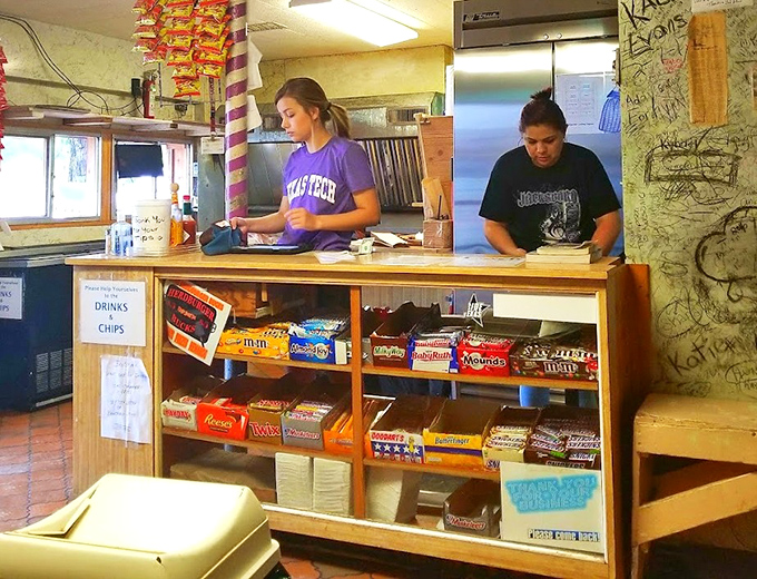The counter where burger dreams come true. No fancy digital systems, just good people making great food with practiced hands.