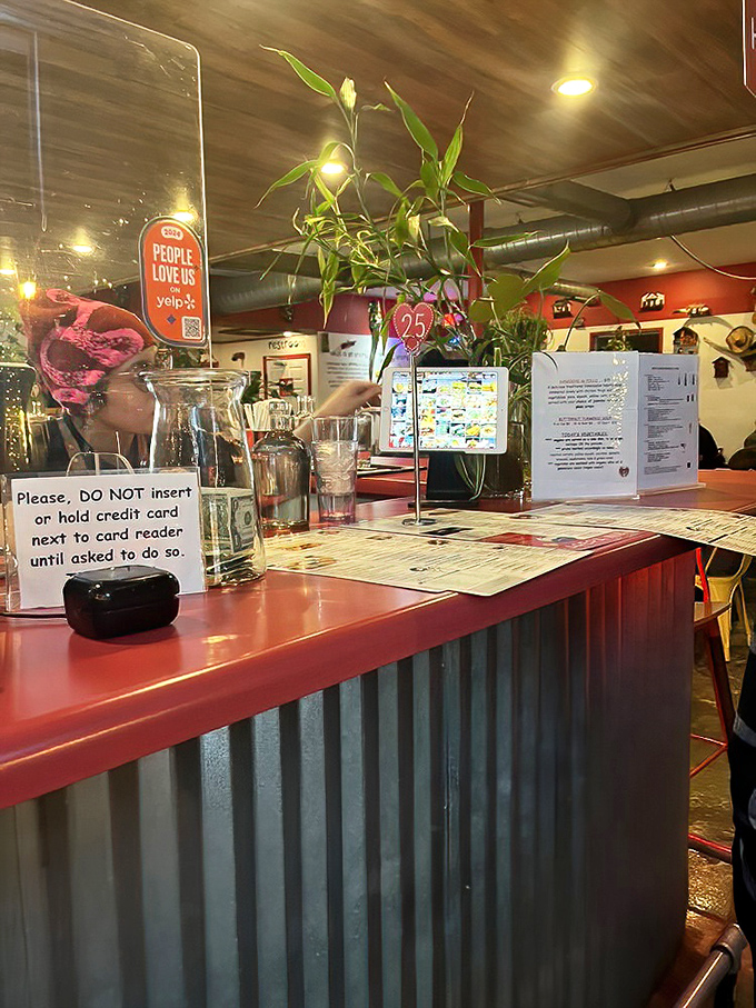 The counter tells stories of hospitality with its bamboo plant and handwritten menus. It's the command center for Venezuelan culinary magic.