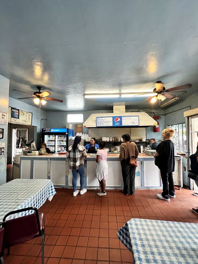The ordering counter&mdash;where dreams are placed and fulfilled with efficient warmth. Notice how everyone waits with patient anticipation rather than impatience.