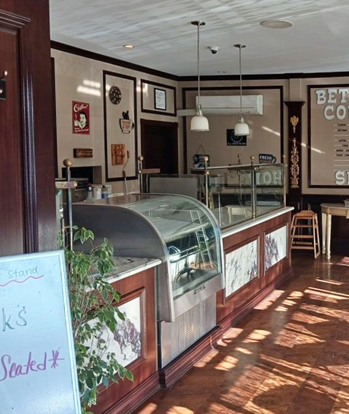 The counter area offers a glimpse into the café's operation – where breakfast magic happens beneath vintage-inspired lighting and classic décor.