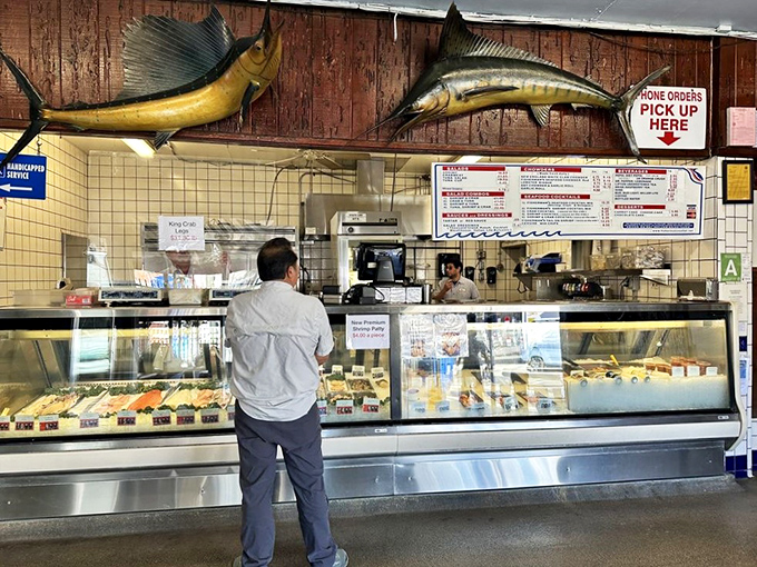 The ordering counter with trophy fish overhead&mdash;where dreams of fresh seafood become delicious reality.