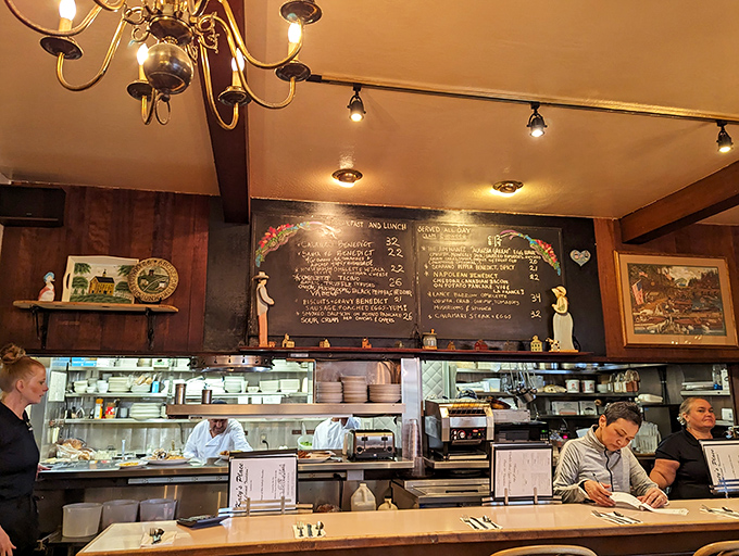 The counter offers front-row seats to the breakfast ballet happening in the open kitchen behind.