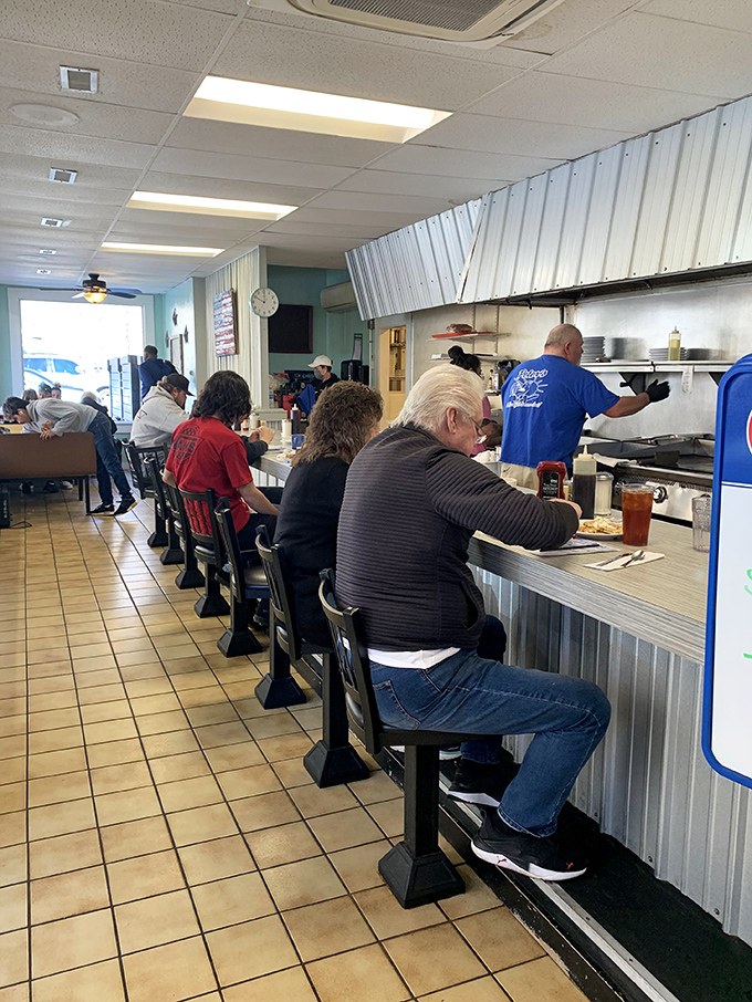 The counter seating offers front-row tickets to the breakfast show. Regulars claim these spots to exchange local wisdom while watching their meals come to life.
