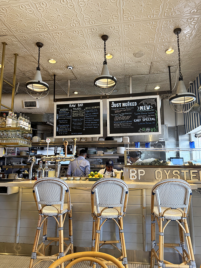 The heart of the operation where chalkboard menus and hanging lights create that perfect casual-chic coastal dining vibe.