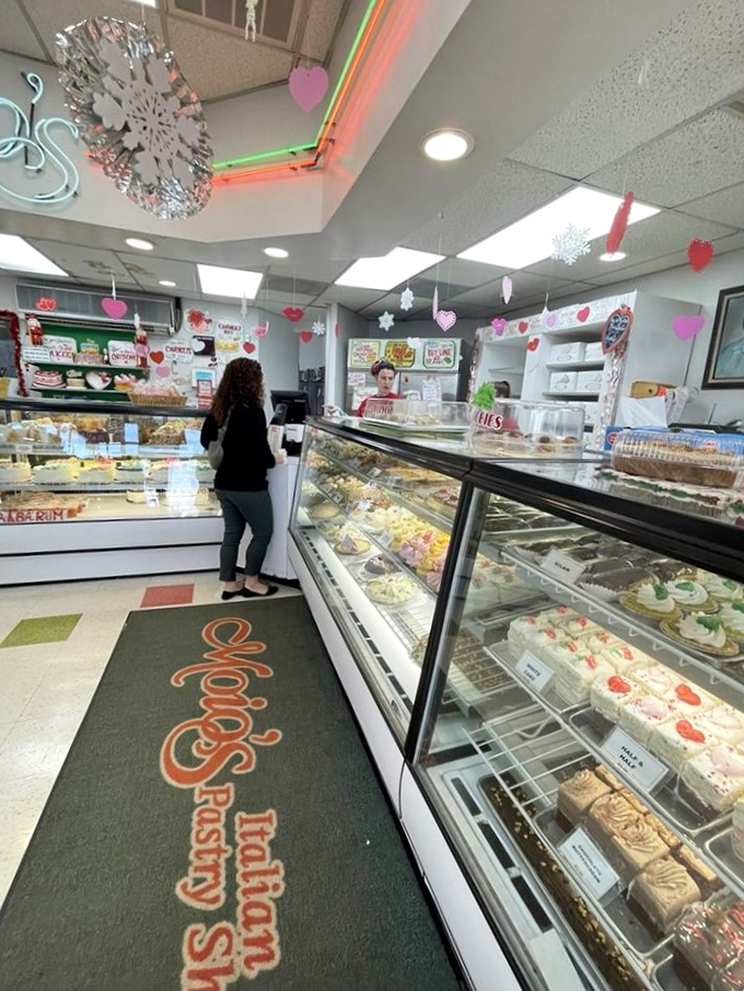 The bakery counter where dreams come true. Notice how everyone waits patiently, knowing that some pleasures are absolutely worth the line.