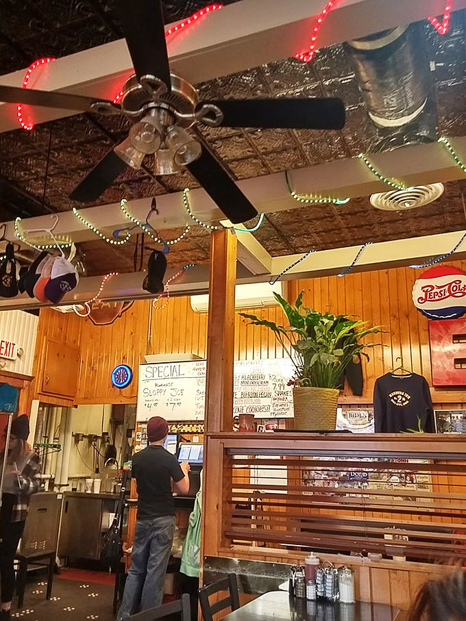 Vintage ceiling fans, string lights, and handwritten specials create the kind of authentic atmosphere that Instagram filters desperately try to capture.