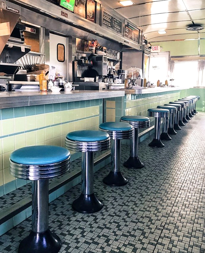 The counter seats—where solo diners become temporary members of the Broadway Diner family. Each blue stool has witnessed countless first dates and morning-after stories.