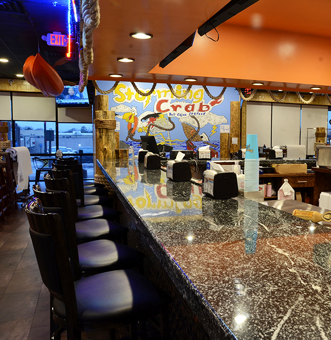 The bar area offers front-row seats to the seafood symphony happening in the kitchen – cocktails with a view.