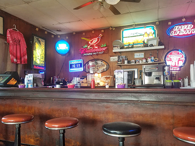Bar stools that have supported generations of Kansans, under the glow of neon that feels more like home than decoration. This counter has heard it all.