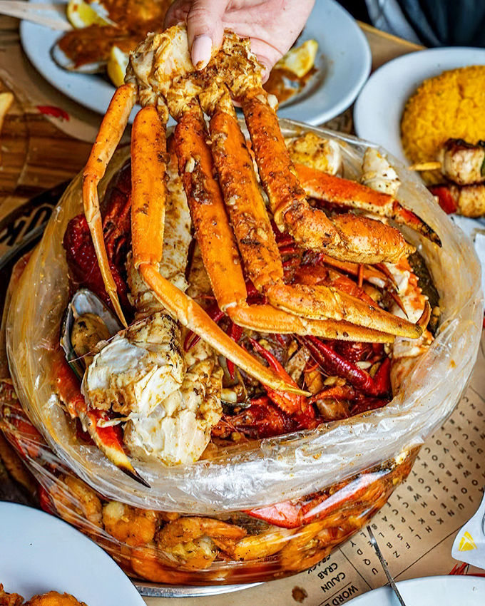 Nature's perfect design: crab legs and crawfish arranged like a delicious sculpture. The ultimate hands-on dining experience awaits.