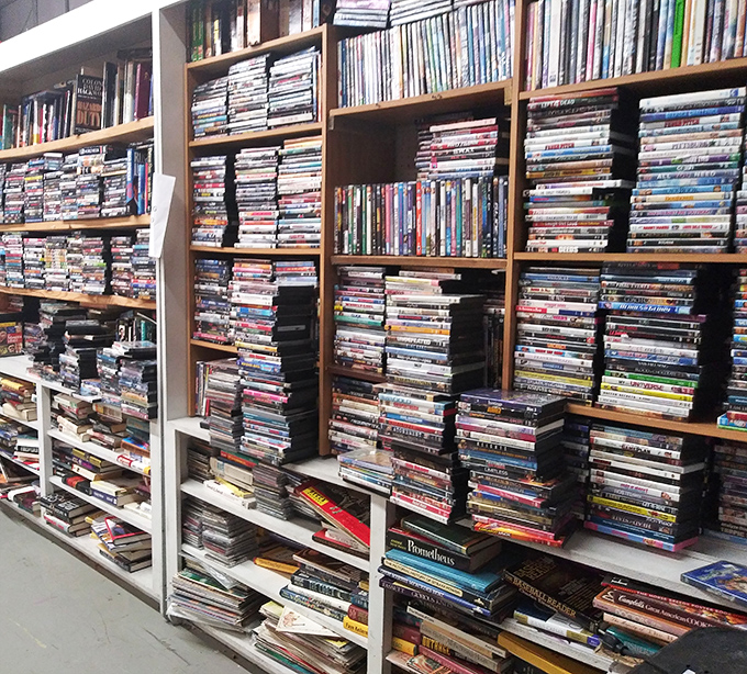 The DVD wall stands as a physical archive of film history, a reminder that streaming can't guarantee your favorite movie will always be available.