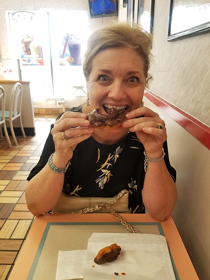 Pure donut joy captured in real-time &ndash; the universal expression that says "why did I wait so long to try this place?"