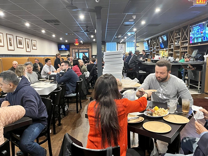 The dining room hums with the satisfied murmur of regulars and first-timers united by the universal language of exceptional pizza.