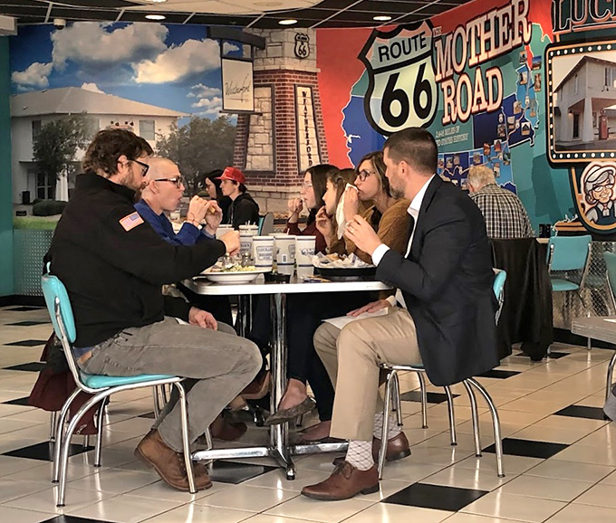 The retro diner section features classic Route 66 murals and chrome-trimmed tables where travelers and locals share stories over plates of American classics.