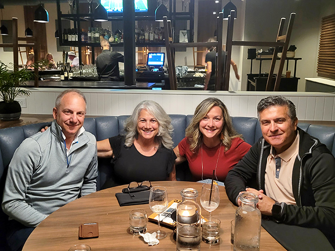 Happy diners sharing stories and small plates—the universal language of good food creating connections across the table.