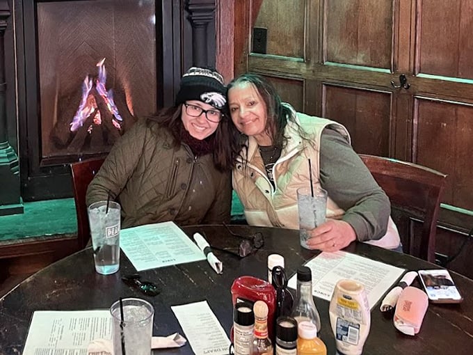 The fireplace creates the perfect backdrop for friends gathering over pints and plates, proving that the best Irish hospitality happens around a warm hearth.