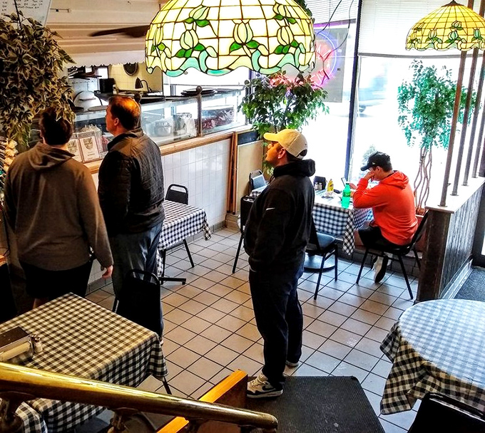 The lunch rush at Mama's&mdash;where locals patiently wait for sandwich greatness. That stained-glass lamp has witnessed thousands of first-bite expressions of pure joy.