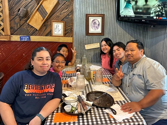 Happy diners gathered around the promise of great food. Notice the lack of phones&mdash;steak this good demands your full attention.