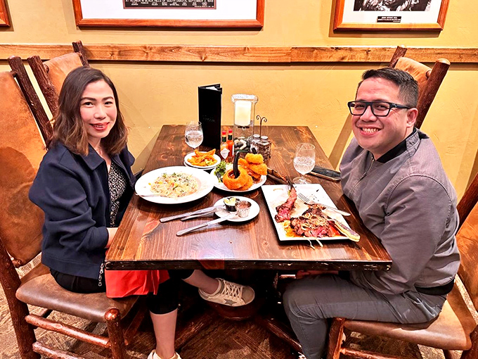 Happy diners surrounded by a spread that would make even the most dedicated food photographer reach for their camera.