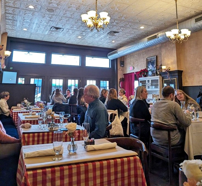 A dining room humming with conversation and clinking glasses. The universal language of good food bringing strangers together under embossed tin ceilings.