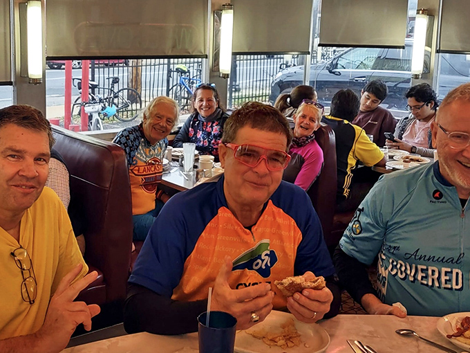 Happy diners sharing stories and calories—the universal language of community that makes Neptune more than just a restaurant.