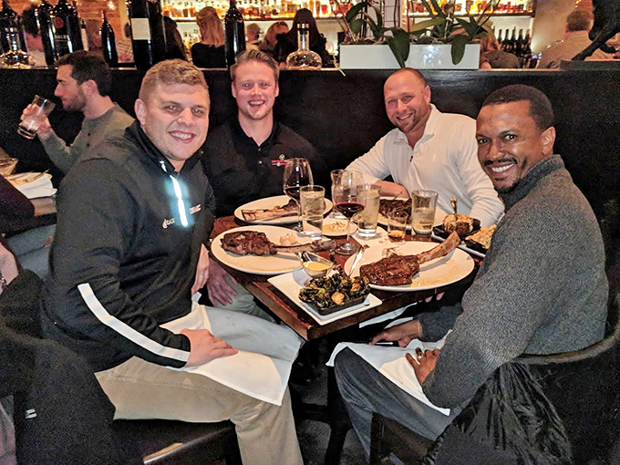 The universal language of steak appreciation. These diners are experiencing what philosophers call "the good life"&mdash;friends, wine, and perfectly cooked beef.