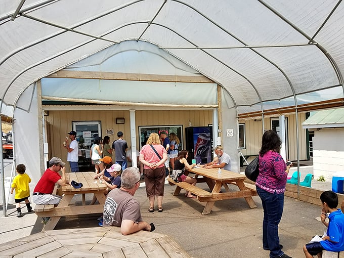 The covered patio where ice cream dreams come true. Families gather at picnic tables, united in the universal language of "mmmmm."