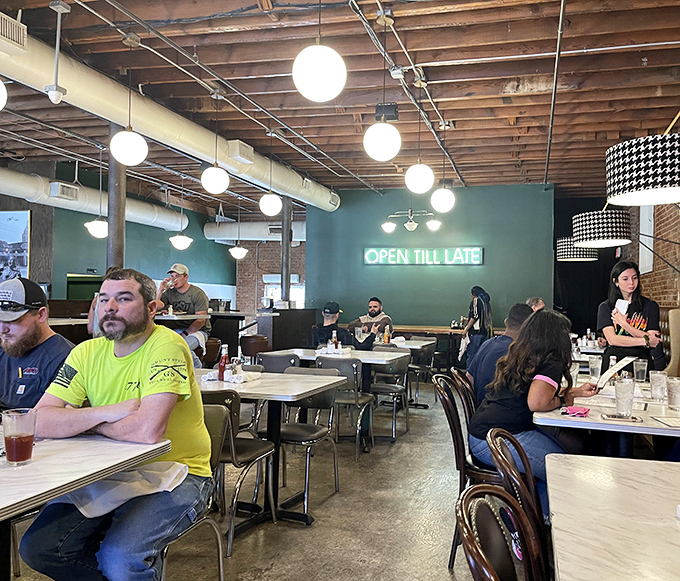 "Open Till Late" glows like a beacon for night owls and breakfast-for-dinner enthusiasts. The diverse crowd proves its universal appeal.