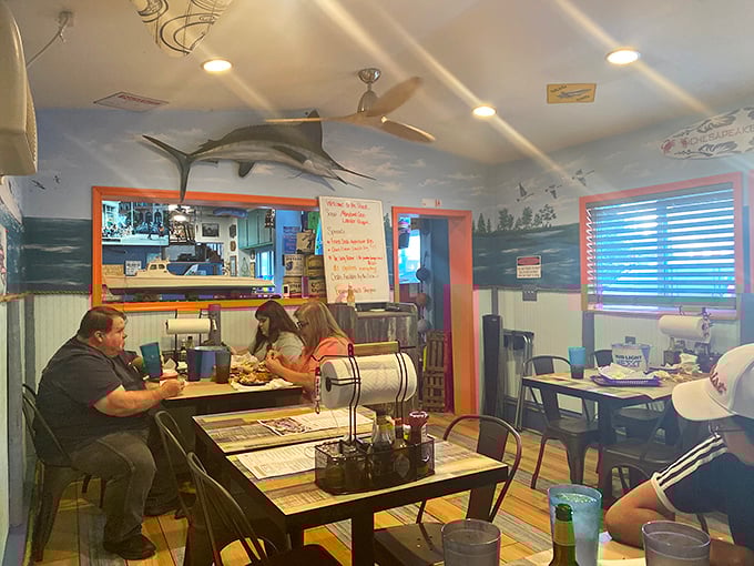 The dining room balances casual comfort with maritime charm&mdash;where metal chairs and paper-covered tables signal it's time to get deliciously messy.