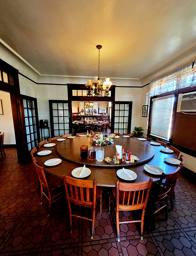 Another dining room, another lazy Susan waiting to be spun into action. The chandelier has witnessed countless "just one more bite" promises.