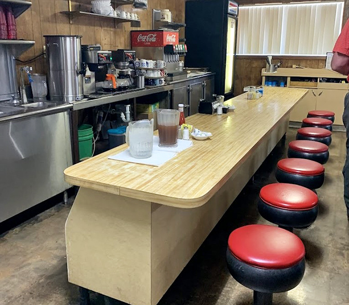 The counter seating offers front-row tickets to the kitchen ballet, where coffee flows freely and regulars exchange news of the day.