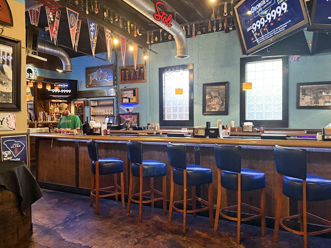 The bar area combines sports memorabilia and comfortable seating, creating that rare space where strangers become friends over shared cheers.