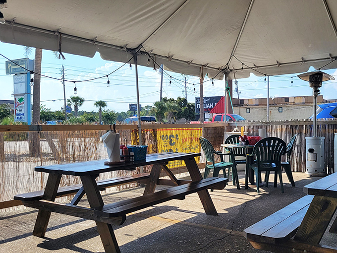 The outdoor dining area &ndash; where salty breezes enhance every bite. Those string lights aren't just decoration; they're setting the stage for seafood memories.