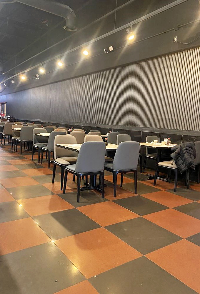 Modern dining room with checkerboard floors where families gather to create memories over endless plates of delicious food.
