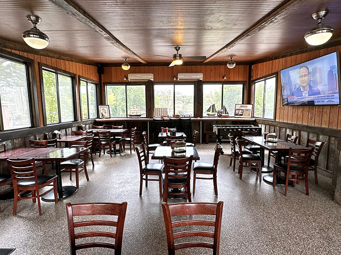 Wood-paneled walls and picture windows create the perfect backdrop for serious barbecue contemplation. Television optional, meat focus essential.
