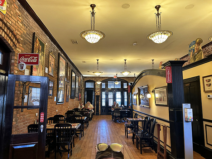 The dining area whispers stories of decades past through exposed brick walls and elegant chandeliers&mdash;casual elegance with a Southern drawl.