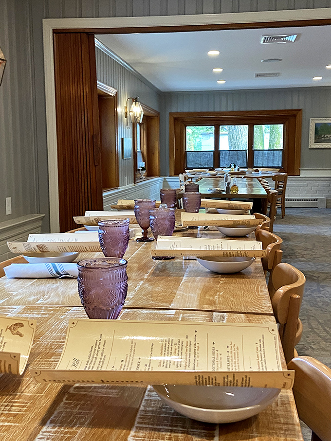 The dining room waits in quiet anticipation, purple glasses adding a regal touch to tables that have hosted countless celebrations.