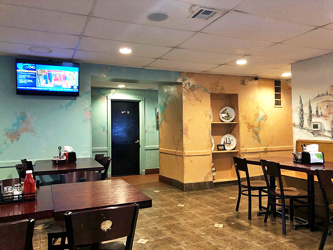 Another dining room angle reveals decorative plates and warm lighting that says "stay awhile, have dessert too."