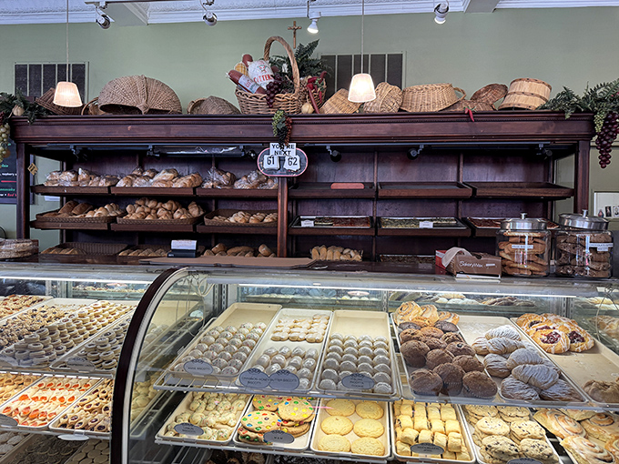 The bread and pastry display&mdash;where carb dreams come true and willpower goes to die, all beneath charming wicker baskets that whisper "you're in good hands."